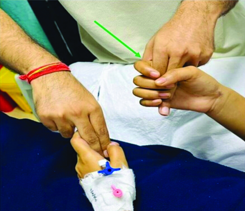 Showing reduced hand grip (green arrow).